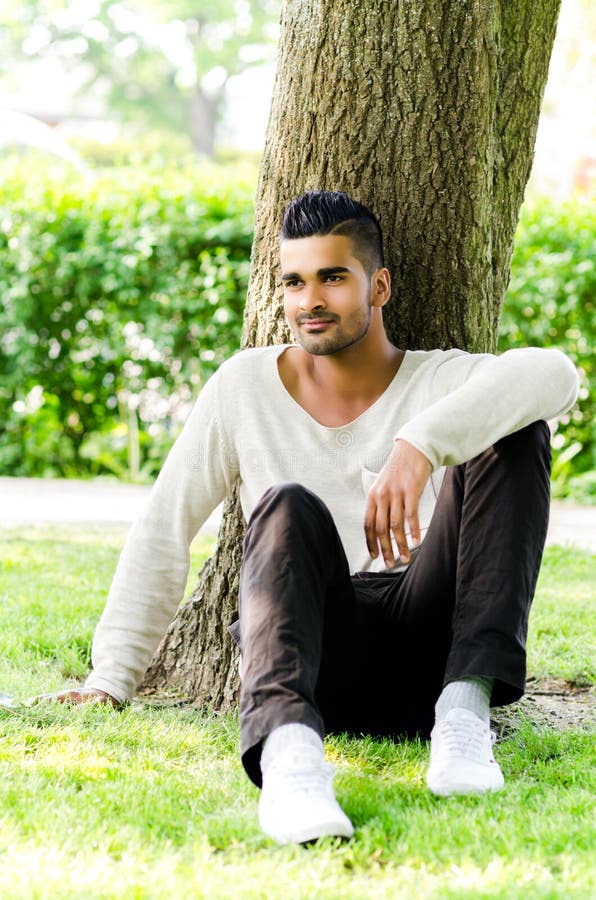 Casual Man Sitting Under a Tree Stock Photo - Image of charm, attitude ...