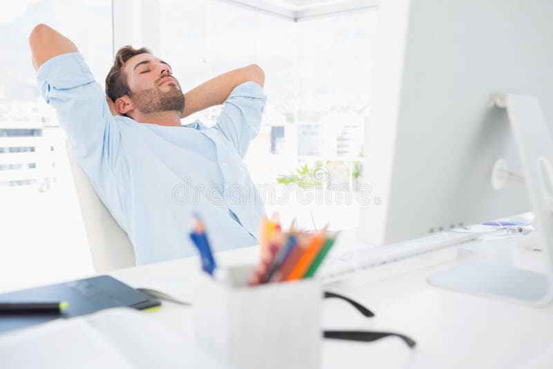 Casual Man Resting with Hands Behind Head in Office Stock Photo - Image ...
