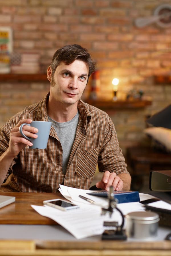 Casual Man Drinking Tea and Working Stock Image - Image of sitting ...