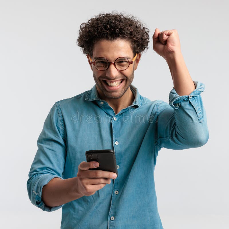 Casual Man Texting on His Phone and Celebrating Success Stock Photo ... Casual Man Texting on His Phone and Celebrating Success Stock Photo ...