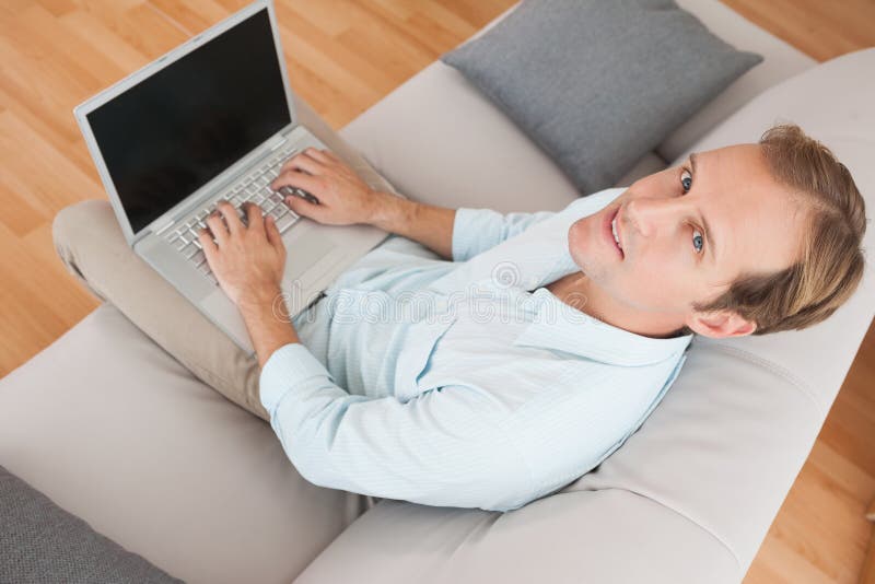 Casual Man Using Laptop on the Couch Stock Image - Image of home ...