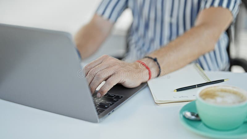 Casual Man Using Laptop at Outdoor Cafe with Coffee and Notebook on ...