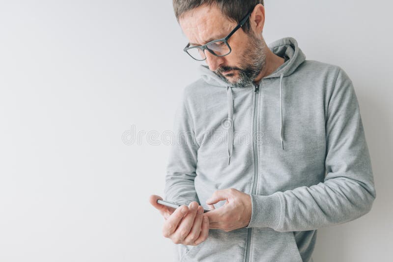 Bored Man Wasting Time Using Mobile Phone Stock Image - Image of ...