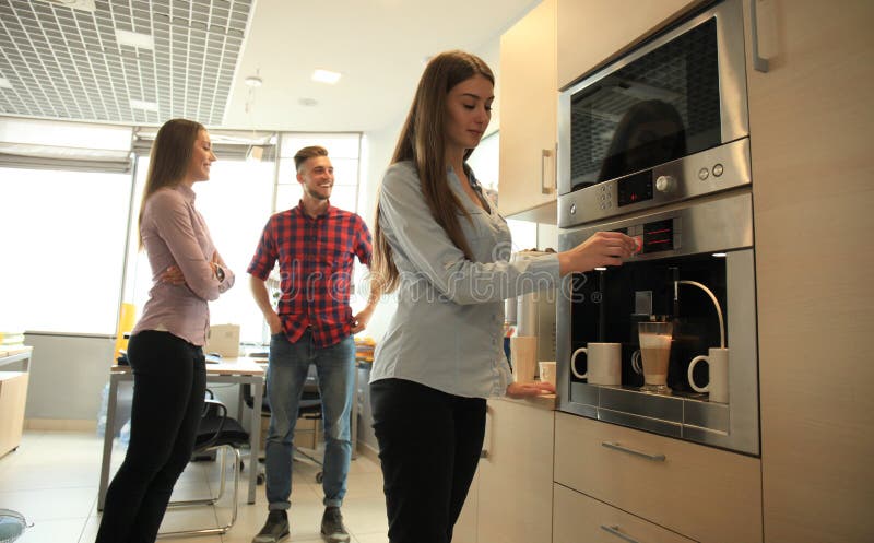 Casual Office People Talking by the Coffee Maker. Stock Photo - Image ...