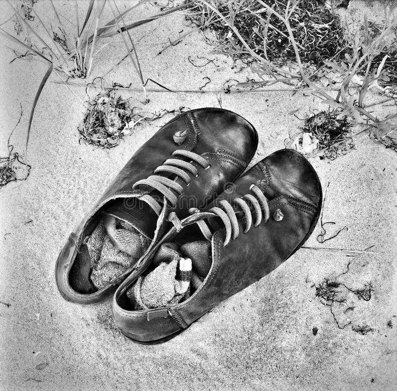 Casual shoes on the sand stock image. Image of footwear - 327743029