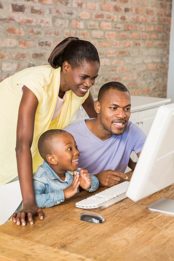 Casual Smiling Family on a Computer Stock Image - Image of family, cute ...