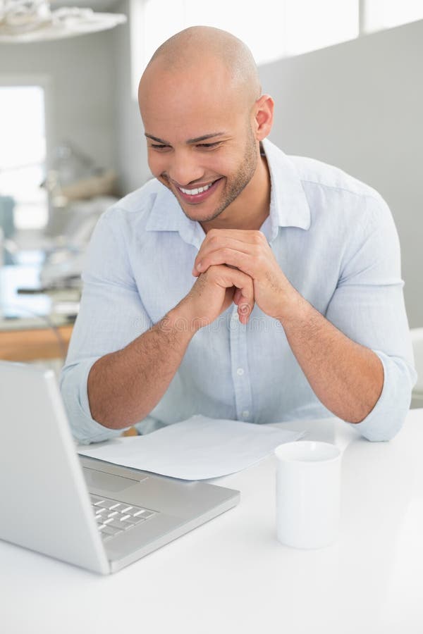Casual Smiling Man Using Laptop at Home Stock Photo - Image of wireless ...