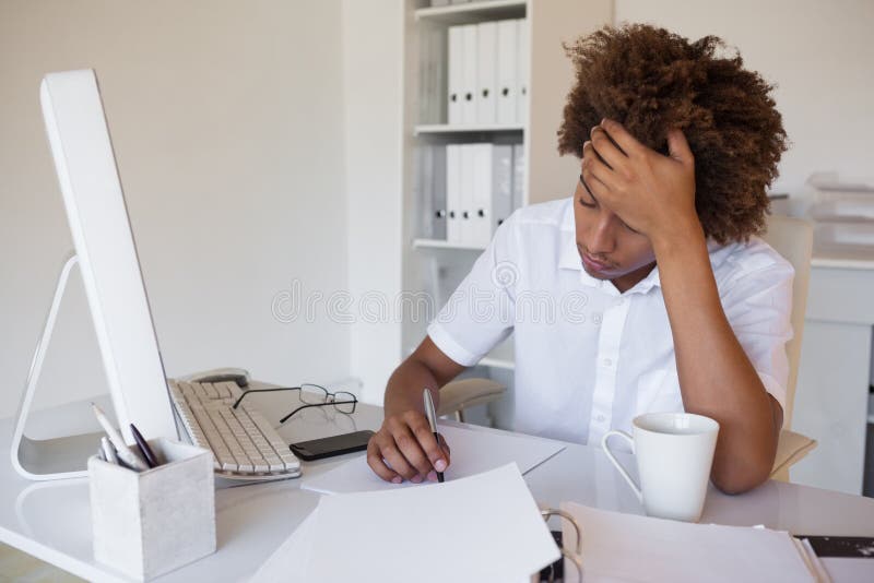Casual Stressed Businessman Writing at His Desk Stock Photo - Image of ...