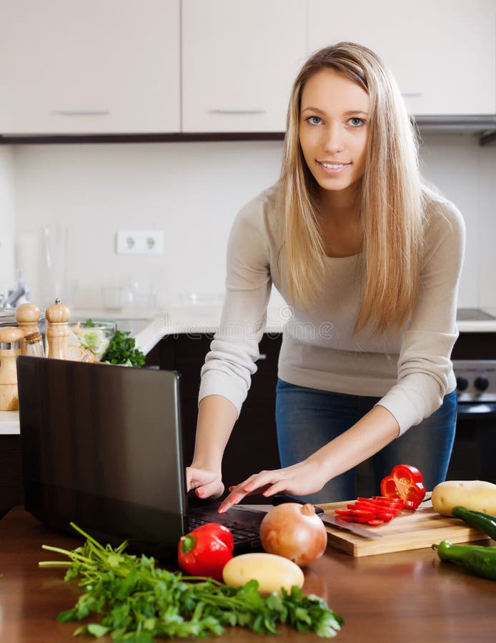 Casual Woman Using Notebook while Cooking Lunch Stock Image - Image of ...