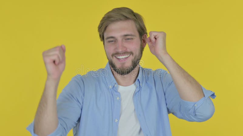 Young Man Dancing in Joy on Yellow Background Stock Photo - Image of ...