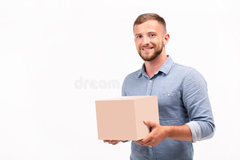 Casual Young Man Holding A Box Isolated On A White Background Stock ... Casual Young Man Holding A Box Isolated On A White Background Stock ...