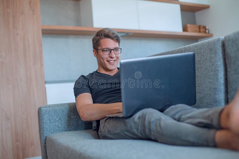 Casual Young Man Looking at His Laptop Screen Stock Photo - Image of ...