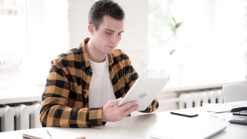 The Casual Young Man Scrolling Internet on Tablet Stock Image - Image ...
