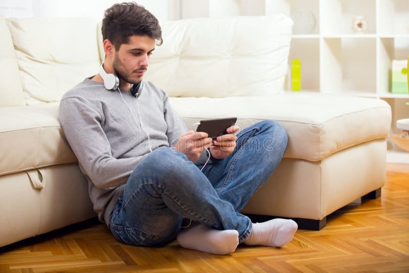 Casual Young Man Using a Tablet at Home Stock Photo - Image of handsome ...