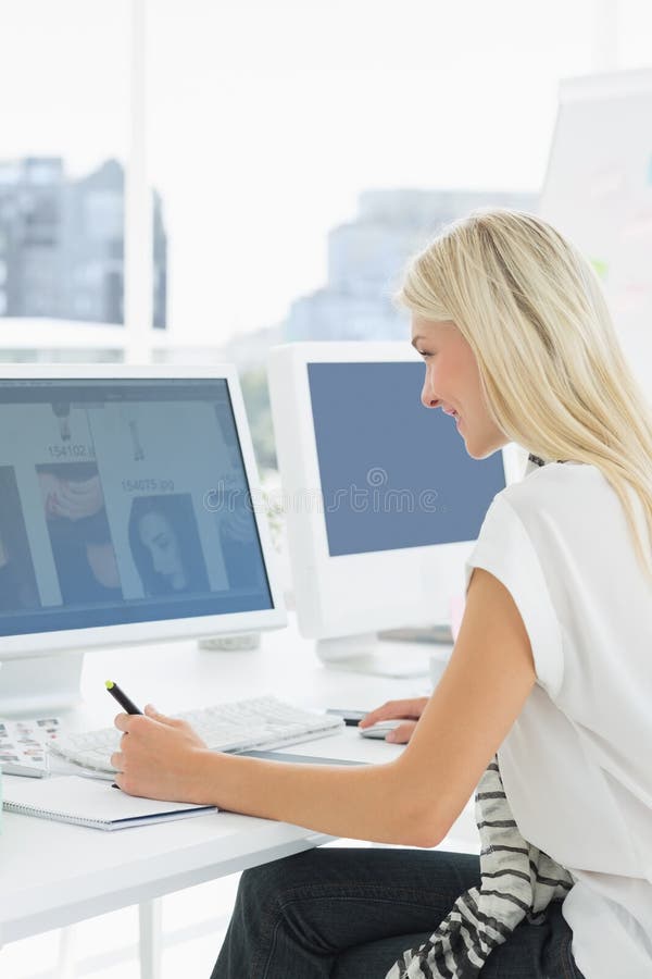 Casual Young Woman Using Computer in Office Stock Image - Image of ...