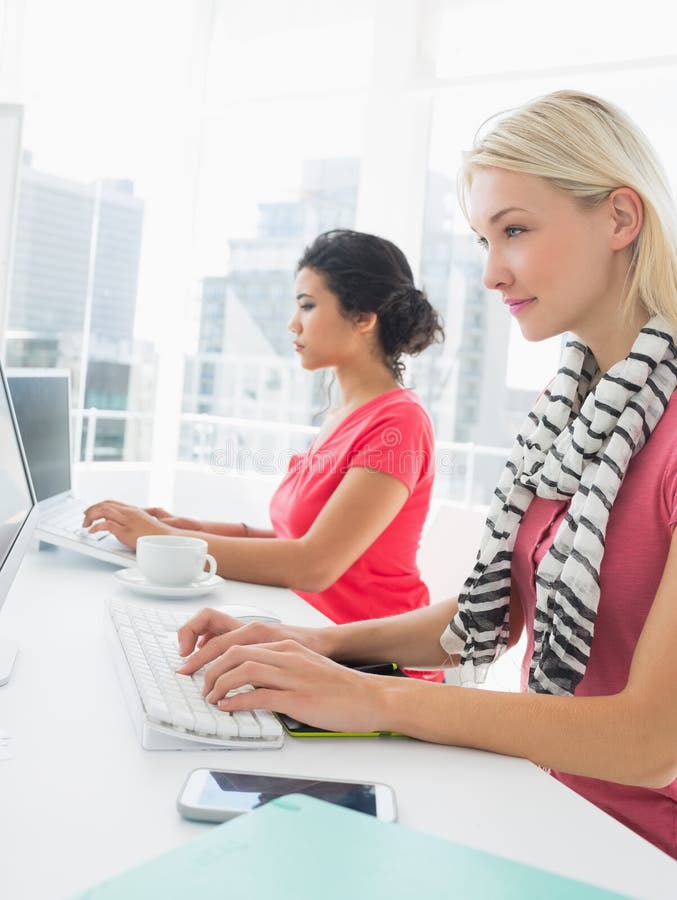 Casual Young Women Using Computers in Office Stock Photo - Image of ...