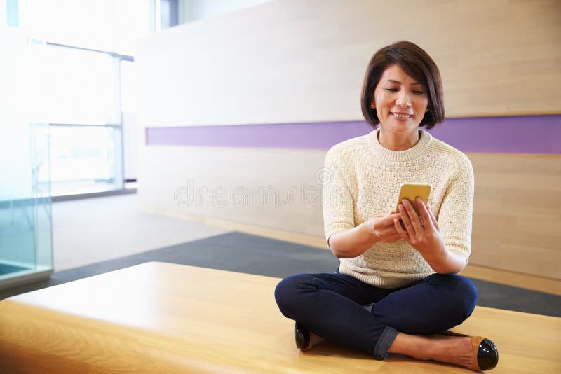 Casually Dressed Chinese Woman Using Smart Phone Stock Photo - Image of ...