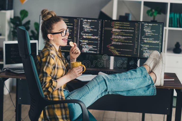 Casually Dressed Female Programmer Working from Home on Coding Project with Coffee and Laptop in ...