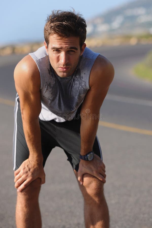 Catching His Breath. Tired Young Runner Leaning Over To Catch His ... Catching His Breath. Tired Young Runner Leaning Over To Catch His ...