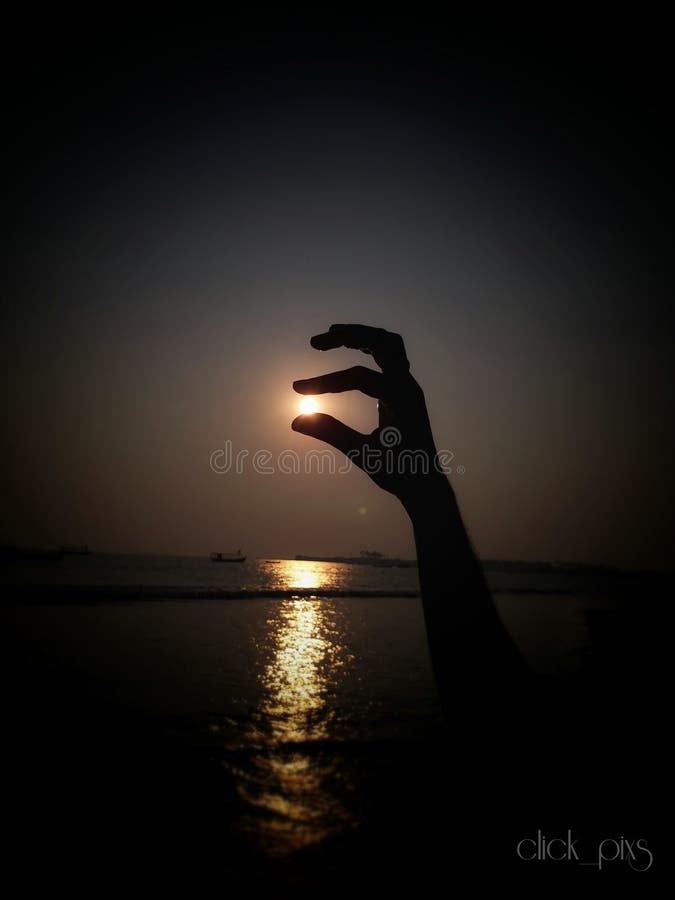 Catching sun with fingers stock photo. Image of holding - 166768034