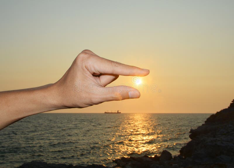 Hand Catching The Sun During The Sunset. Stock Photo - Image of light ...