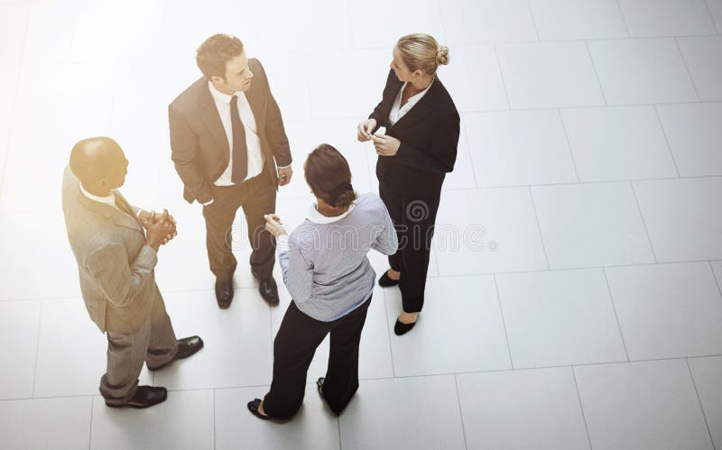 Catching Up. High Angle Shot of a Group of Businesspeople Talking in ...