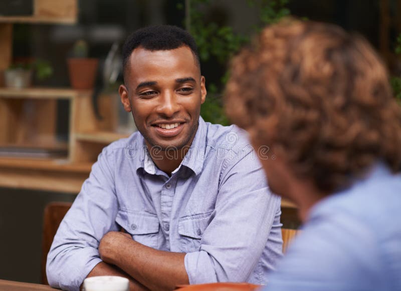 Catching Up with an Old Friend. a Handsome Young Man Sitting with a ...