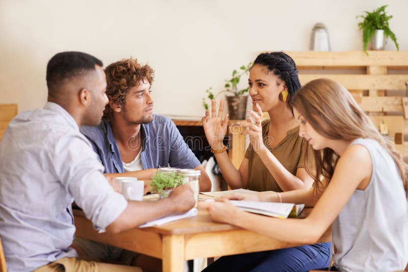 Catching Up with Old Friends. Shot of a Group of Friends Talking in a ...