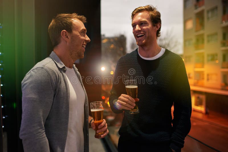 Catching Up Over Some Beers. Guys Talking while Drinking Beer at a ...