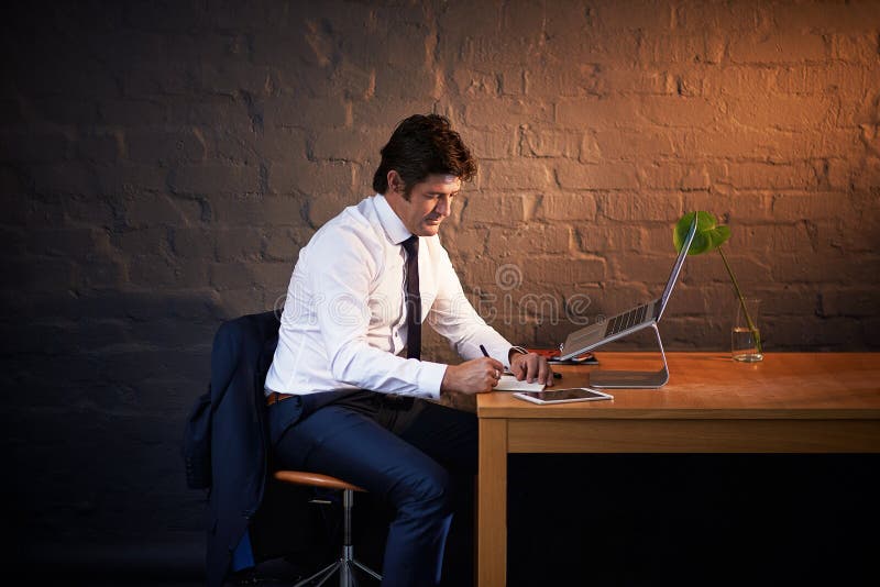 Catching Up on Some Admin. a Businessman Working Late at the Office ...