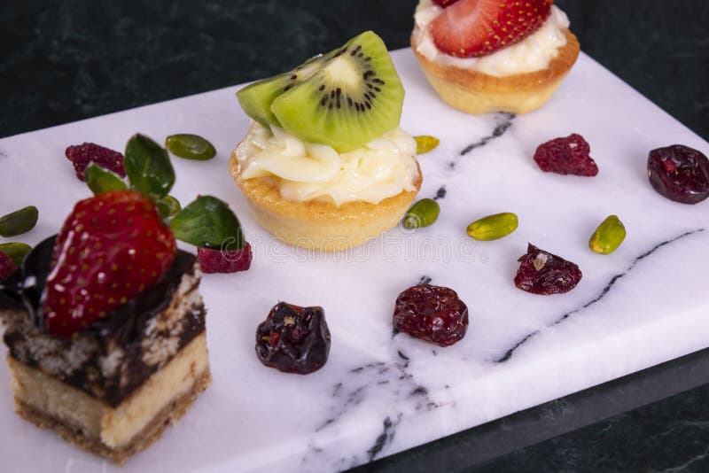 Assorted Different Mini Cakes with Cream, Chocolate and Berries. Stock ...