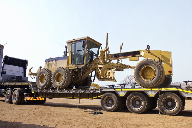 Caterpillar 140H Transporter - on Flatbed Trailer Stock Photo - Image ...