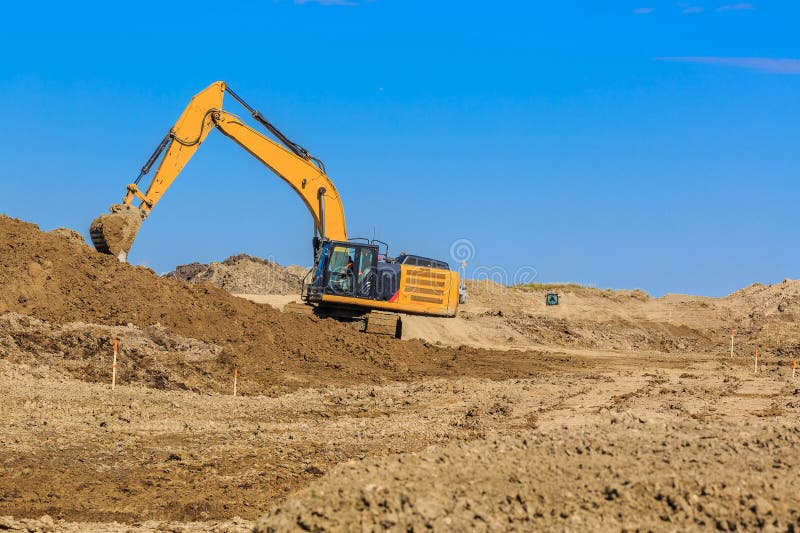 Caterpillar Excavator is Digging into the Ground Stock Photo - Image of ...