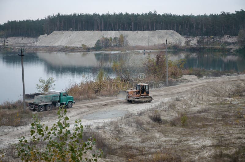 Caterpillar Loader and Dump Truck Works at the Opencast Mining Quarry ...
