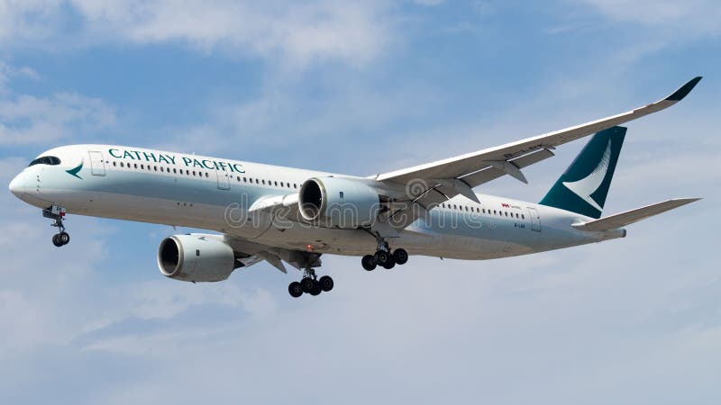 Cathay Pacific Airlines Aircraft Soaring Against a Blue Sky Backdrop ...