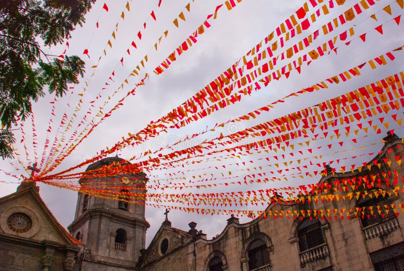 Catholic Cathedral with Red Ribbons and Flags in the Evening. Manila ...