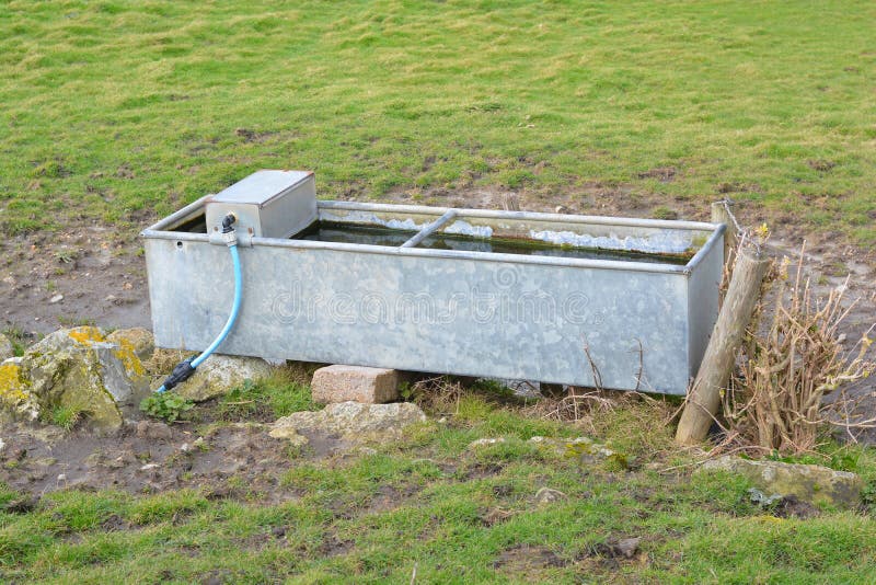 Drinking trough on a field stock image. Image of steel - 25057779