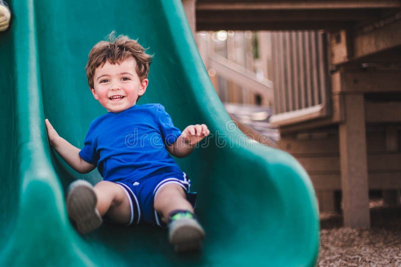 Caucasian Boy Feeling Happy while Sliding on the Playground Stock Image ...