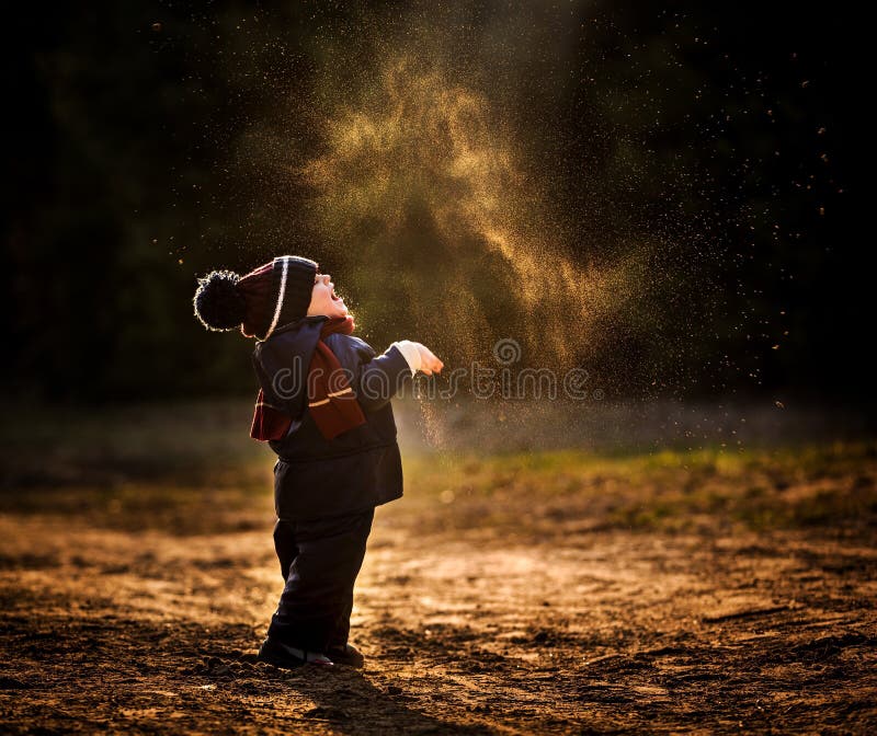 Caucasian Boy Playing Outdoor at Springtime. Boy is Throwing Sand Stock ...
