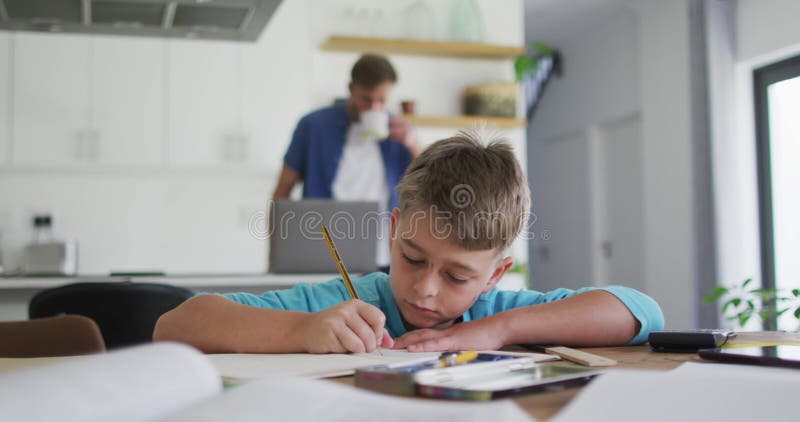 Caucasian Boy Sitting at Table Doing School Work at Home Stock Video ...
