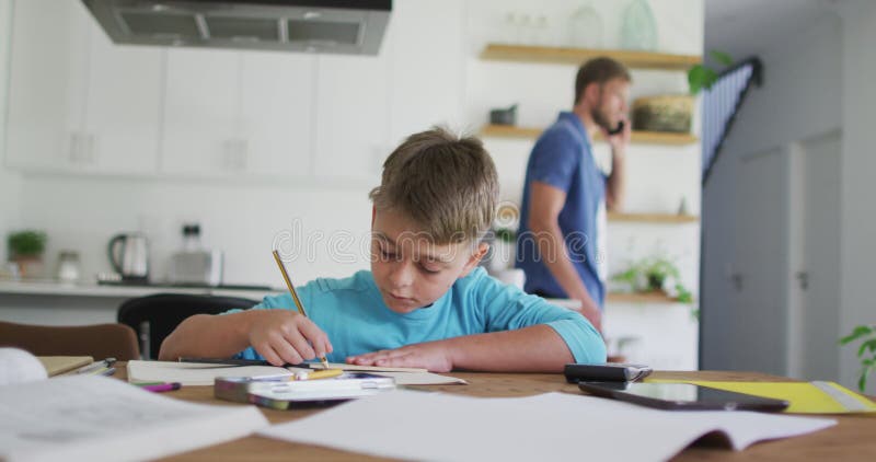 Caucasian Boy Sitting at Table Doing School Work at Home Stock Video ...