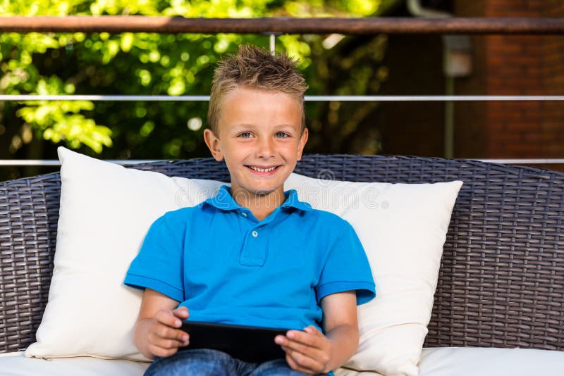 Smiling boy with tablet stock photo. Image of reader - 41592408