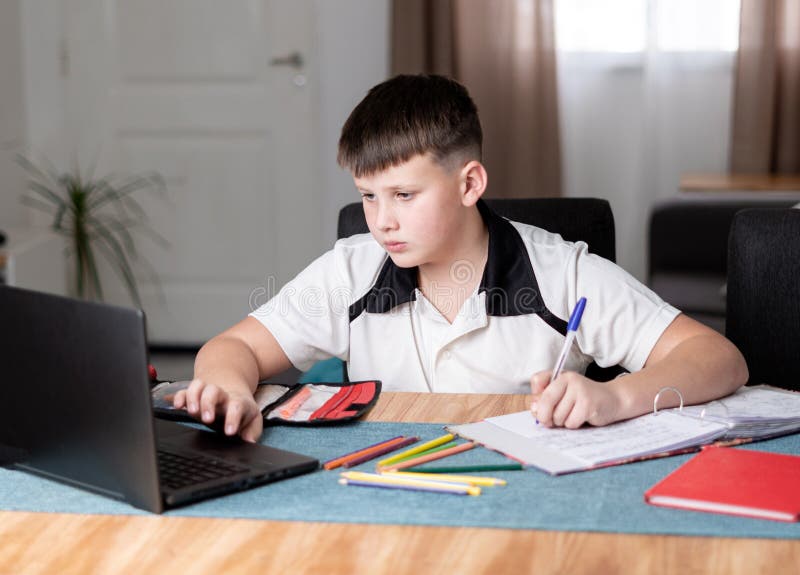 Caucasian Boy Using His Computer while Doing Homework Stock Photo ...