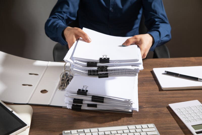 Caucasian Businessman Holding Documents in Office Stock Image - Image ...