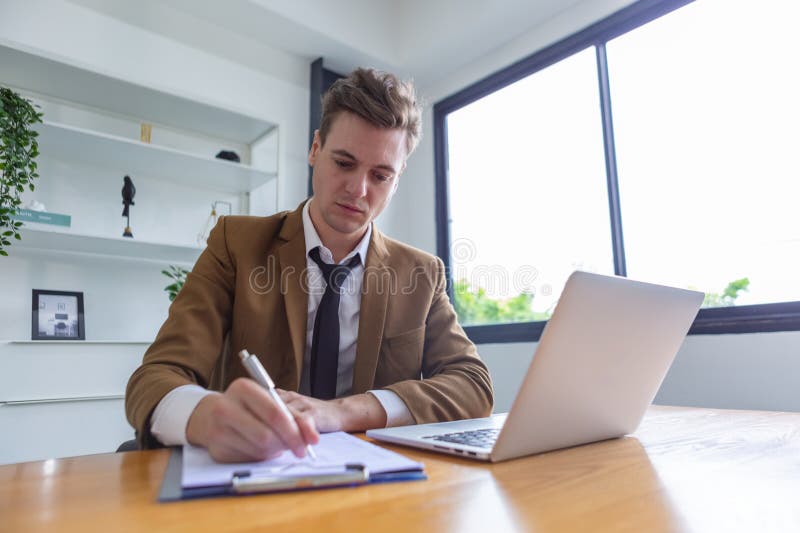 On the Table are Reports, Notepads, Cash, a White Calculator and a ...
