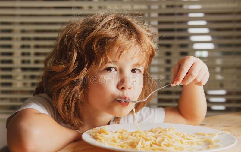 Caucasian Child Eating Pasta, Spaghetti. Kids Funny Face. Stock Photo ...