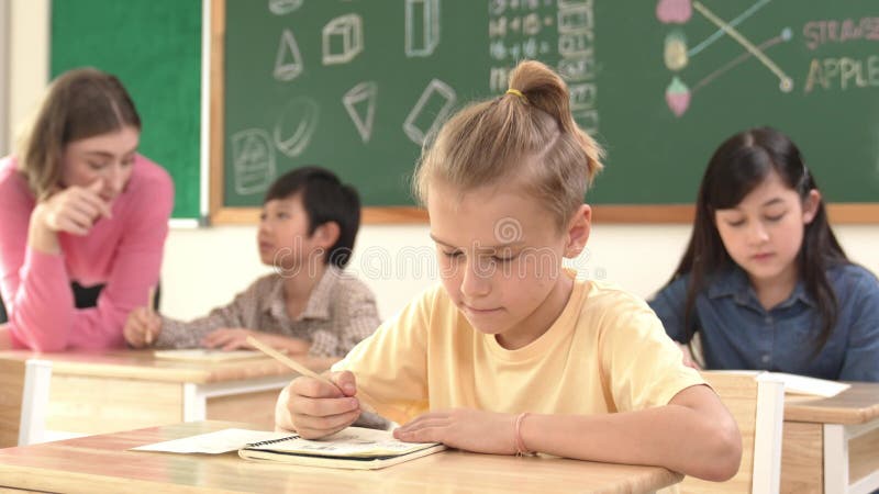 Caucasian Child Smiling at Camera while Doing Classwork at Classroom ...