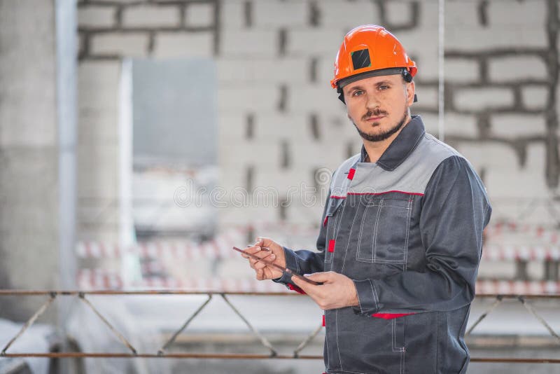 Caucasian Construction Foreman Controlling Building Site with Plan on Digital Tablet, Copy Space ...