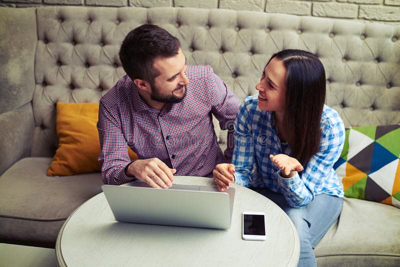 Caucasian Couple Sitting on Sofa and Talking Stock Photo - Image of ...