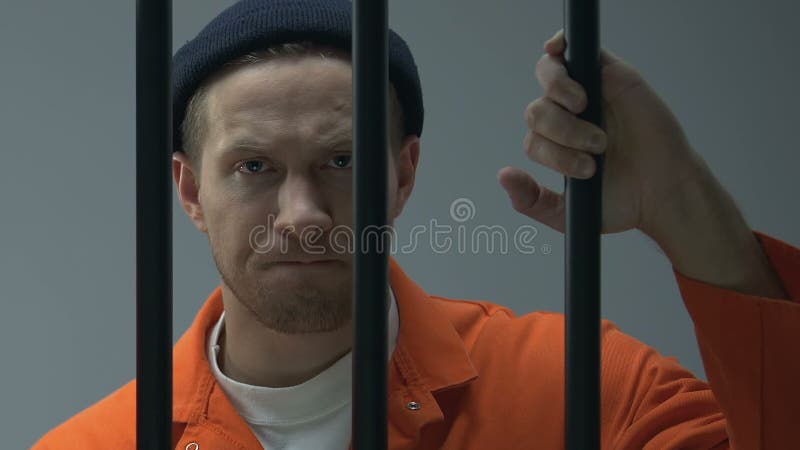 Criminal Looking Out from Prison Cell through the Jail Bars Closeup ...